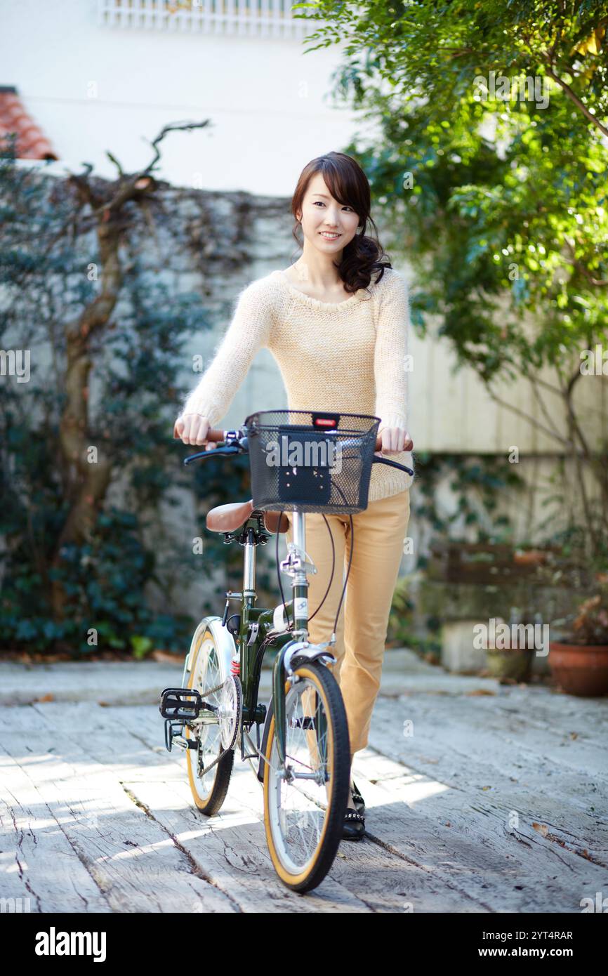 Woman pushing her bicycle hi-res stock photography and images - Alamy