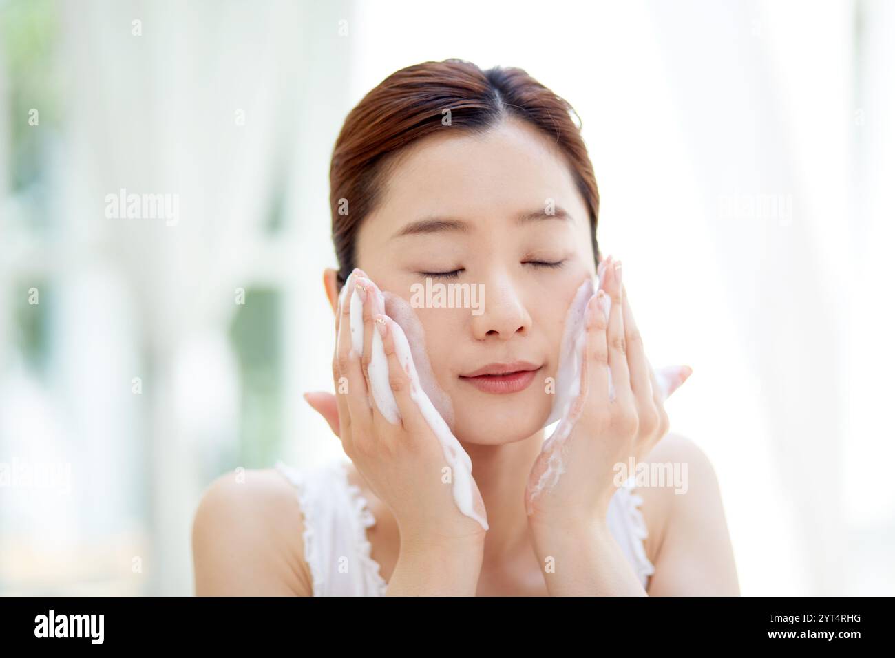 Woman washing face Stock Photo - Alamy