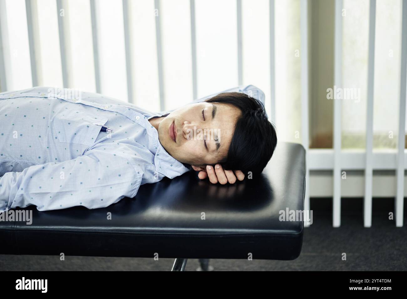 Man lying on bench Stock Photo - Alamy