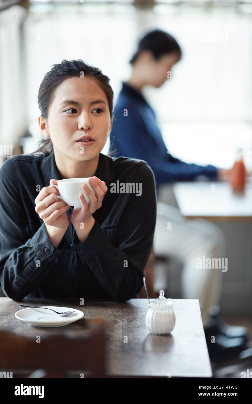 Women drinking coffee at a café Stock Photo - Alamy