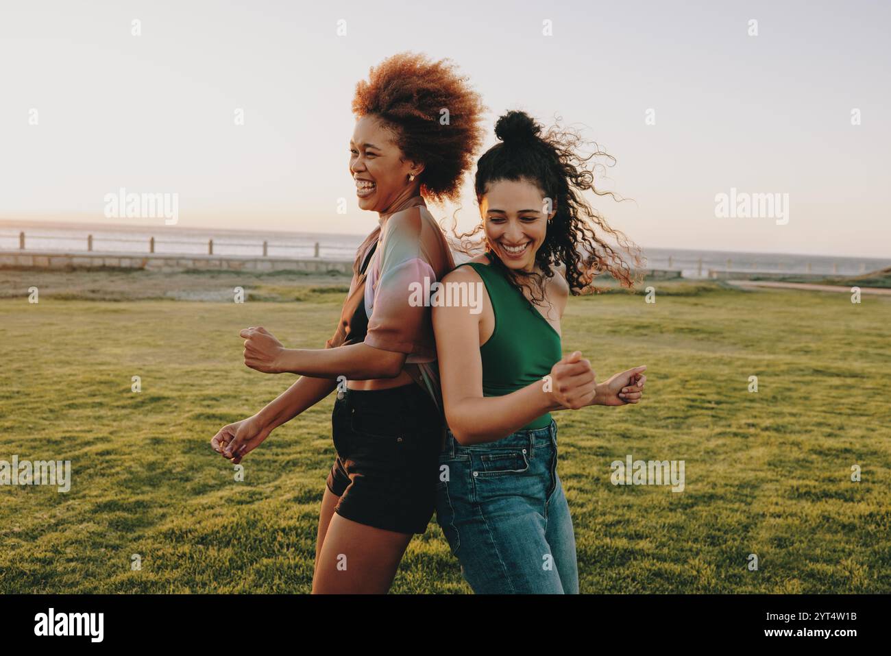 Joyful Gen Z friends dancing together in the outdoors, enjoying the ...