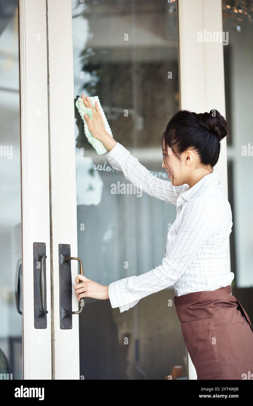 Café worker cleaning Stock Photo - Alamy