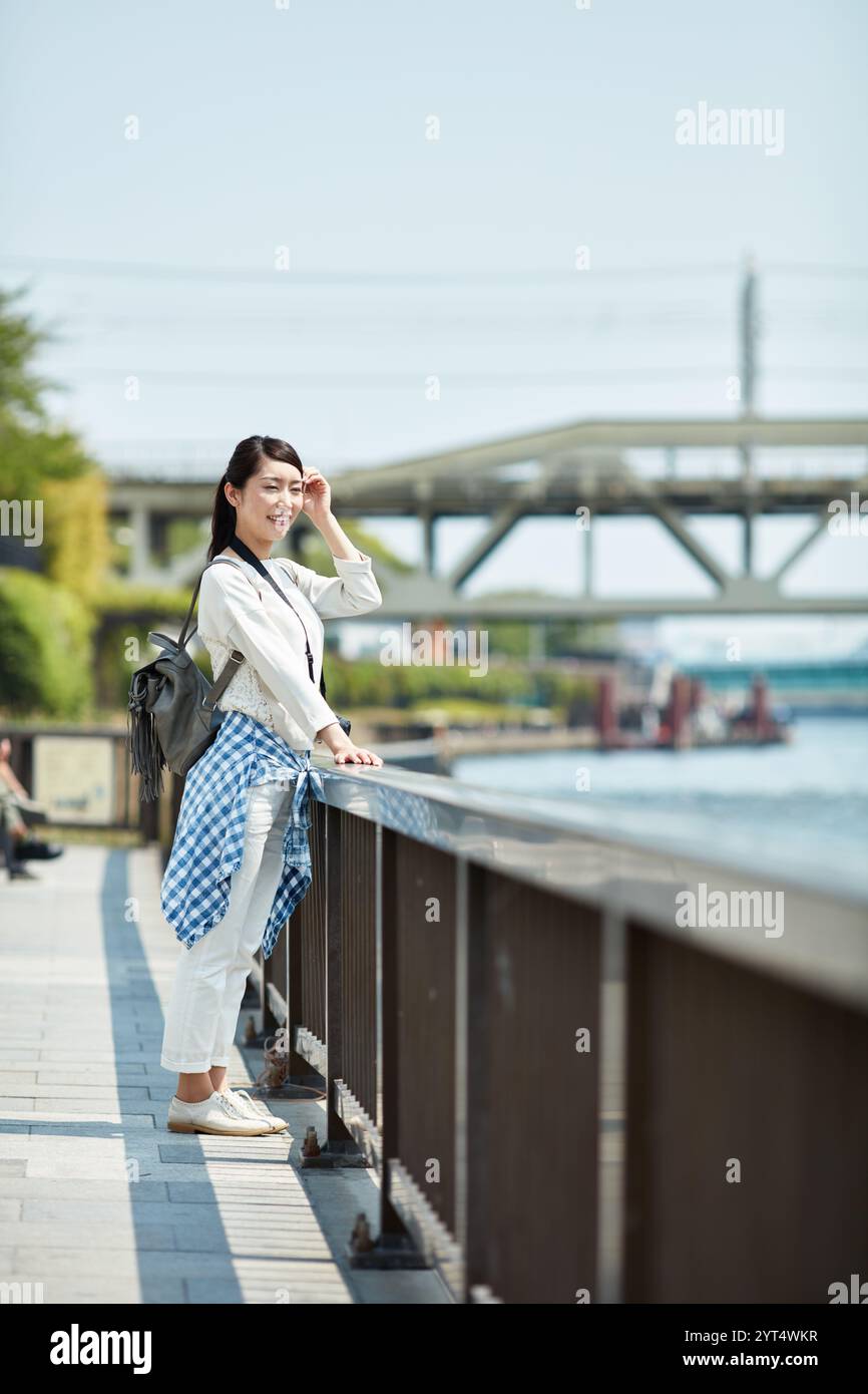 Refreshing woman on the riverside Stock Photo - Alamy