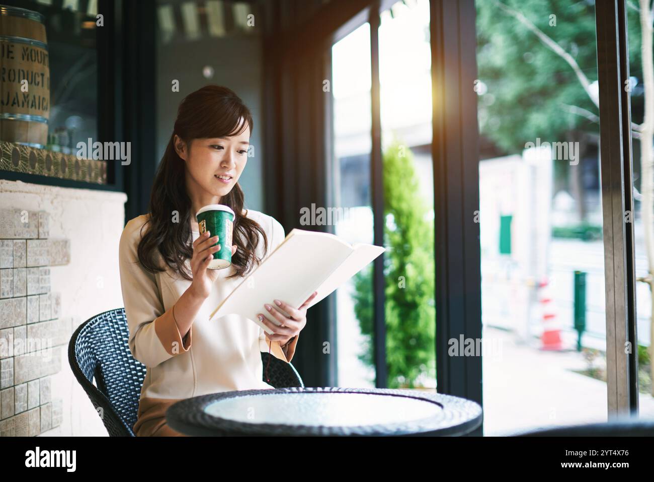Woman book drinks coffee hi-res stock photography and images - Alamy