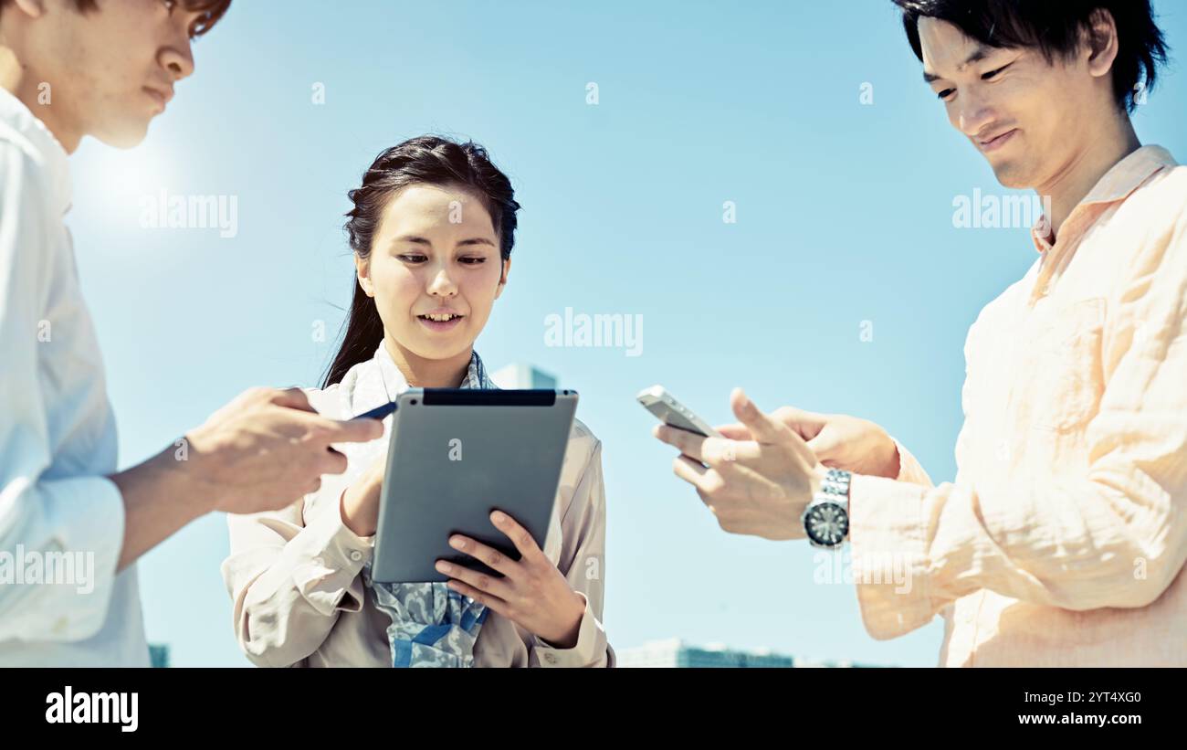 Young people using mobile devices Stock Photo - Alamy