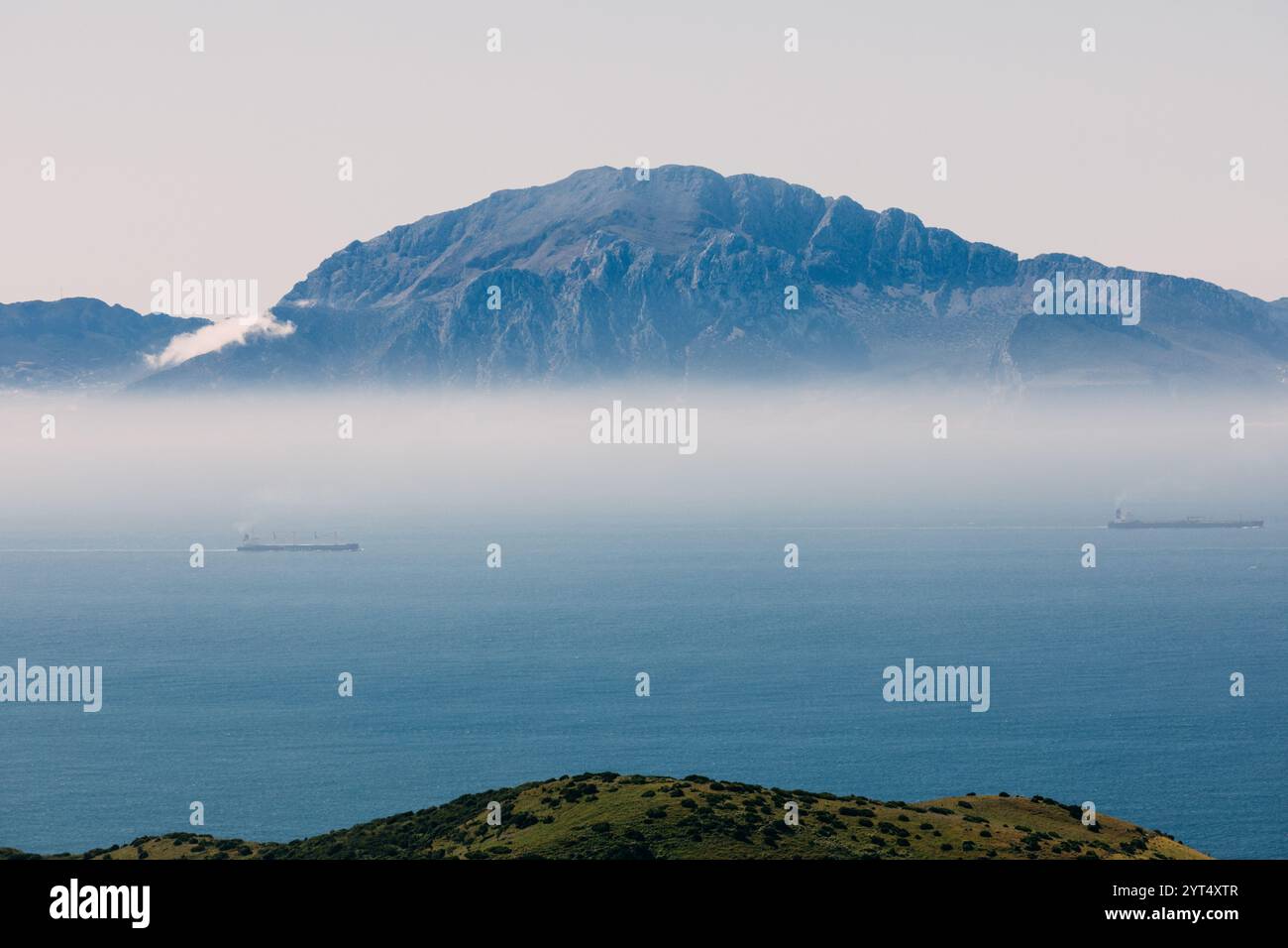 Ships passing through the strait of Gibraltar with mountain scenery ...