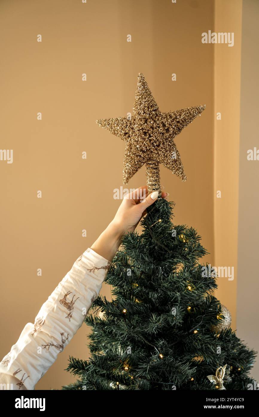 Decorating the Christmas Tree with the Star Stock Photo - Alamy