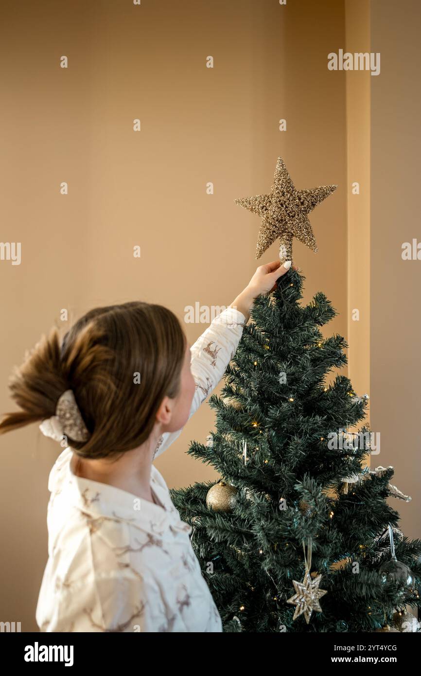 Woman decorating festive christmas tree hi-res stock photography and ...