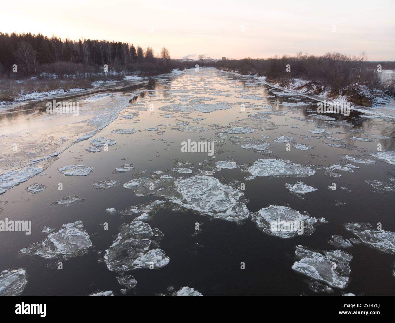 A frozen river with a lot of ice floating on the surface Stock Photo ...