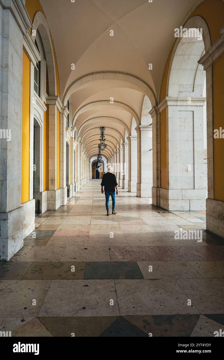 Man walking in Covered walkway Stock Photo - Alamy