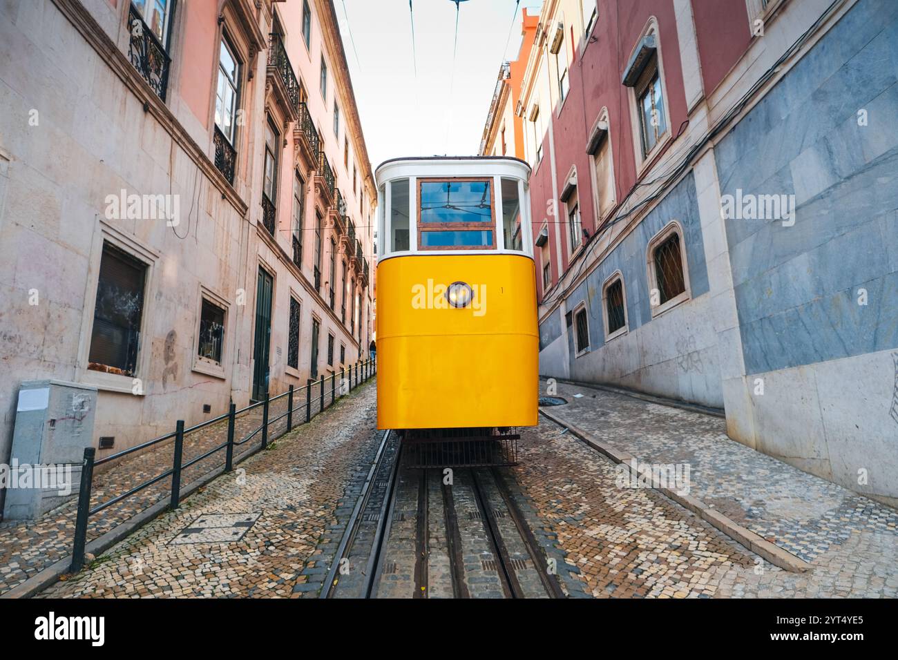 Famous retro yellow funicular tram in narrow streets of Lisbon Stock ...