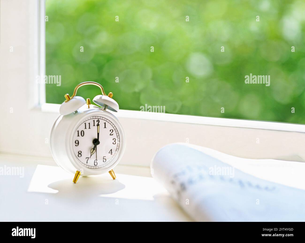 Alarm clock and newspaper Stock Photo - Alamy