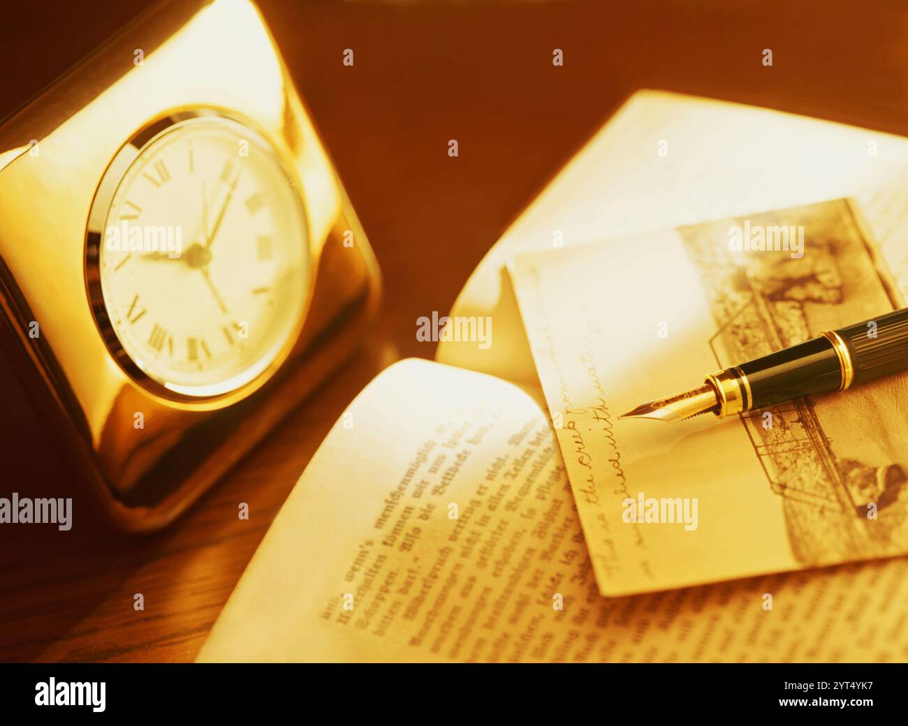 Clock, book and fountain pen Stock Photo - Alamy