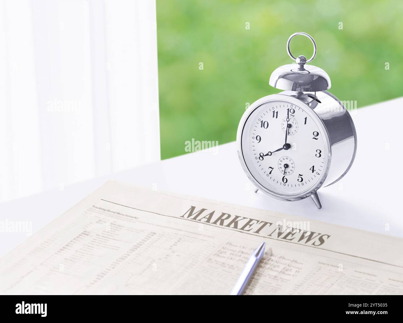 Alarm clock and newspaper on the windowsill Stock Photo - Alamy