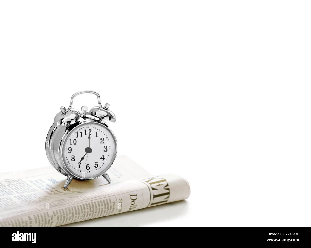 Alarm clock and newspaper Stock Photo - Alamy