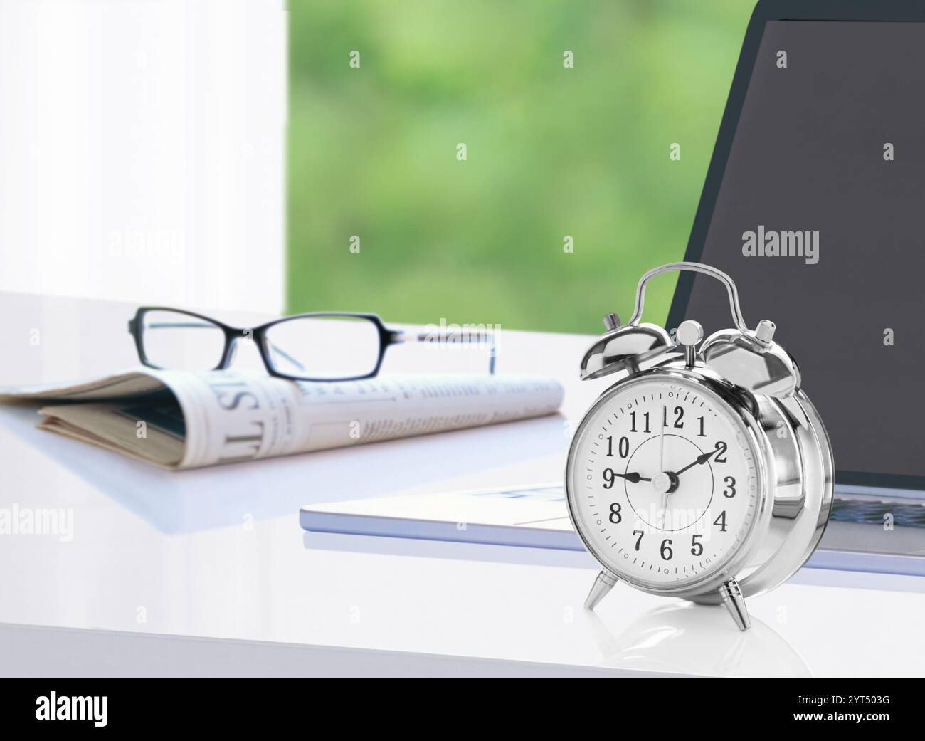 Alarm clock, computer and newspaper Stock Photo - Alamy