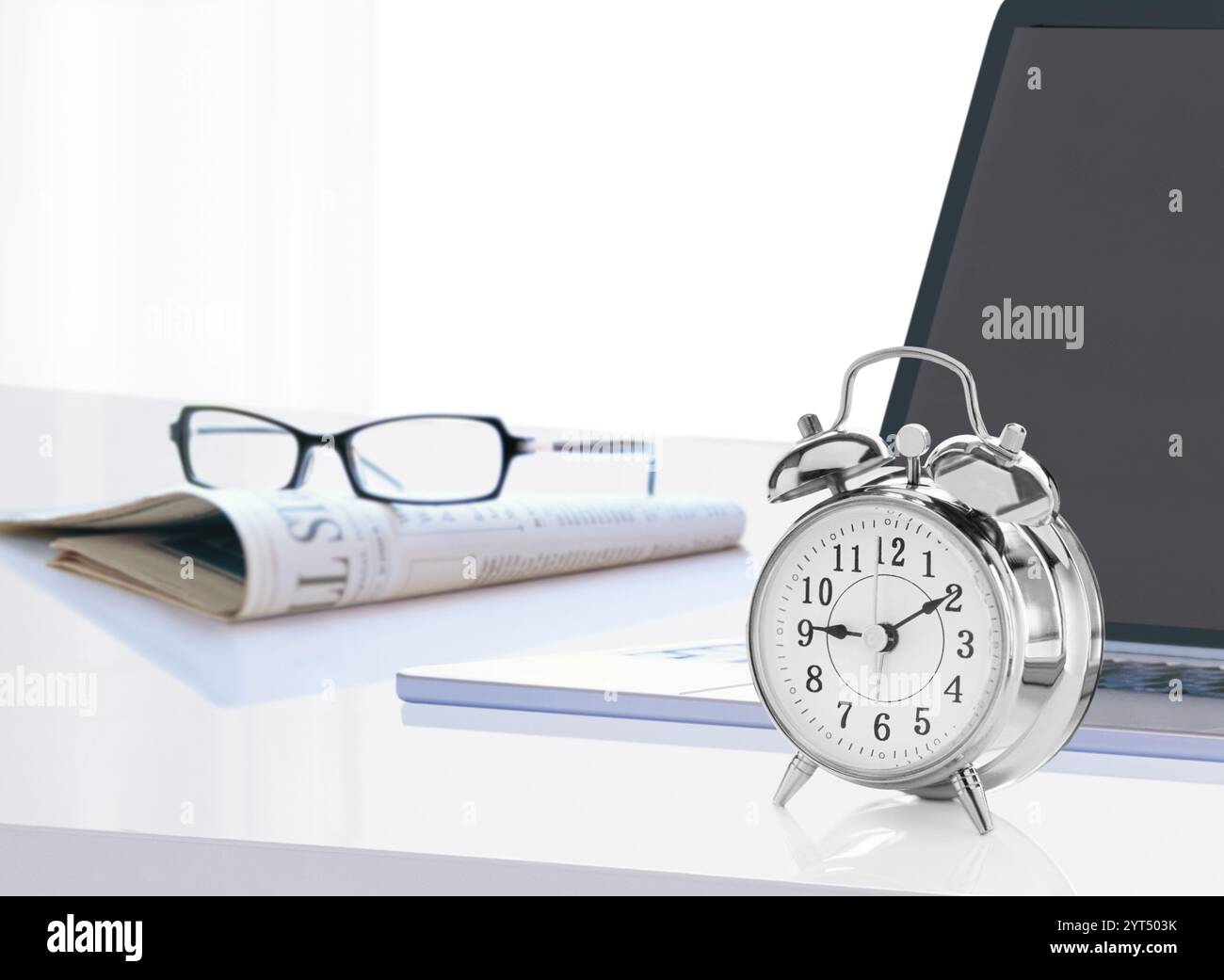 Alarm clock, computer and newspaper Stock Photo - Alamy