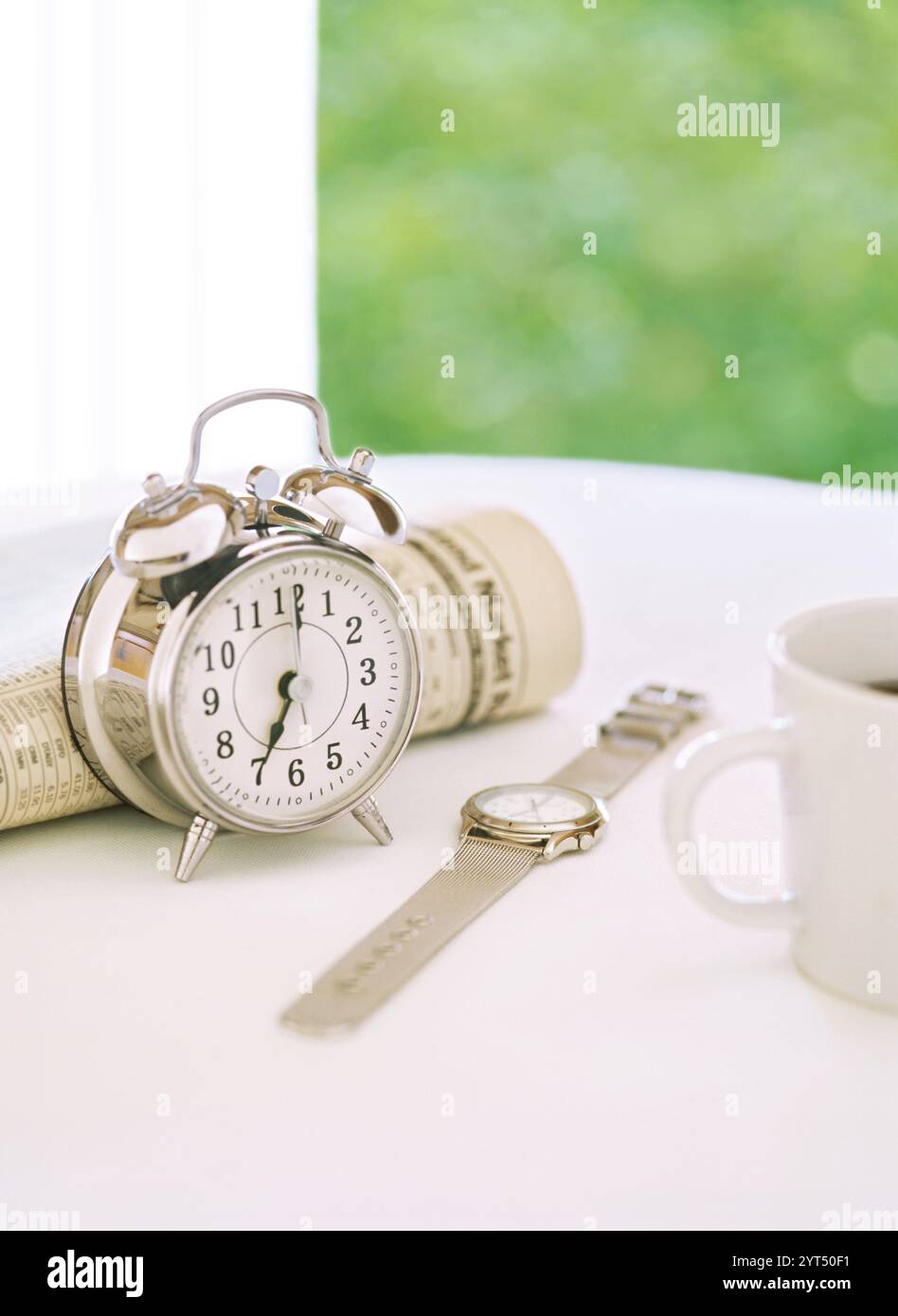 Alarm clock, newspaper and coffee Stock Photo - Alamy