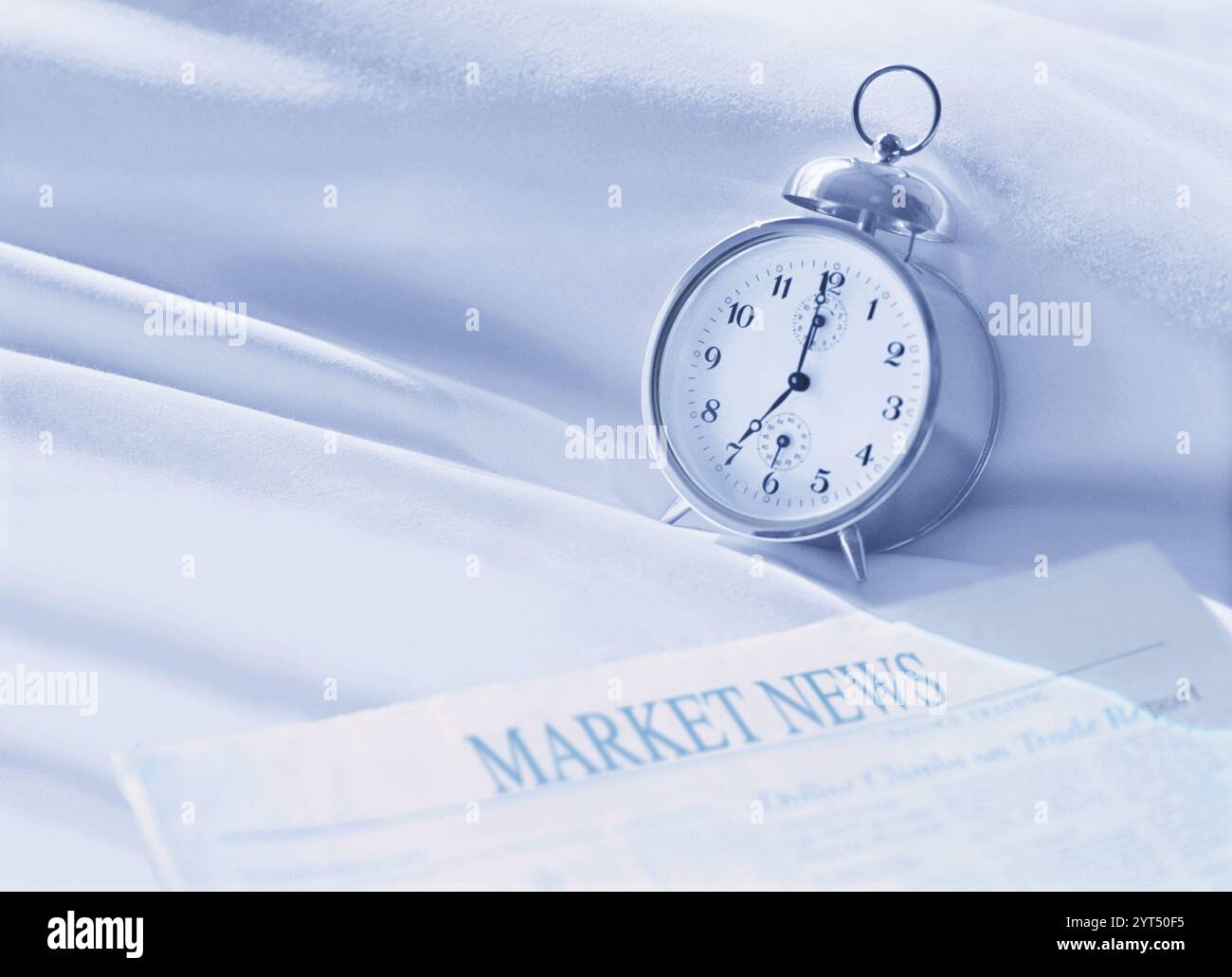 English newspaper and alarm clock Stock Photo - Alamy