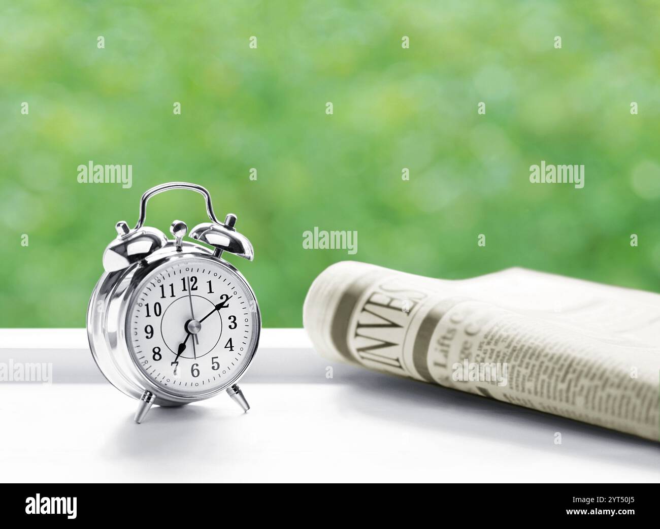 Windowsill clock and newspaper Stock Photo - Alamy