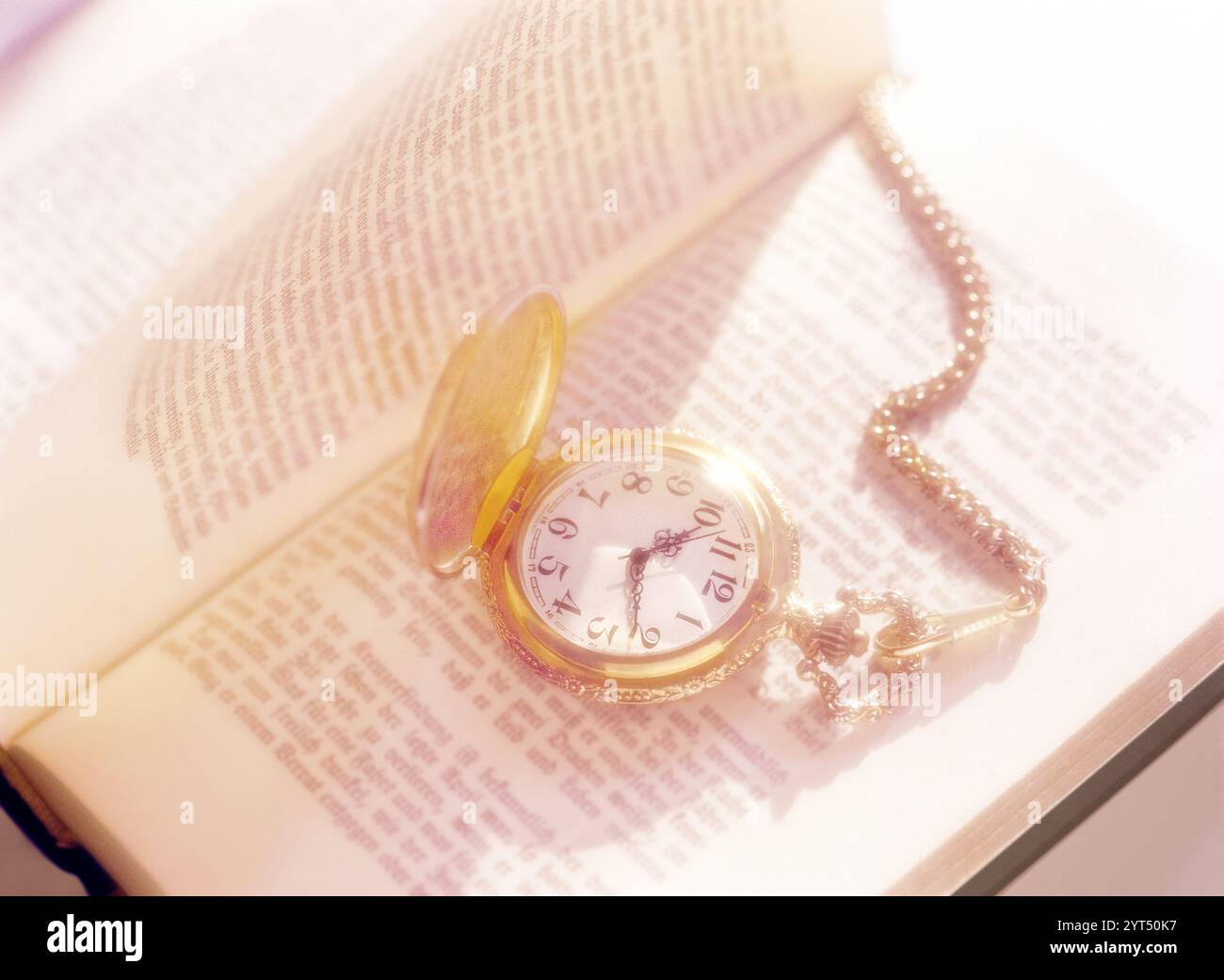 Book and pocket watch Stock Photo - Alamy