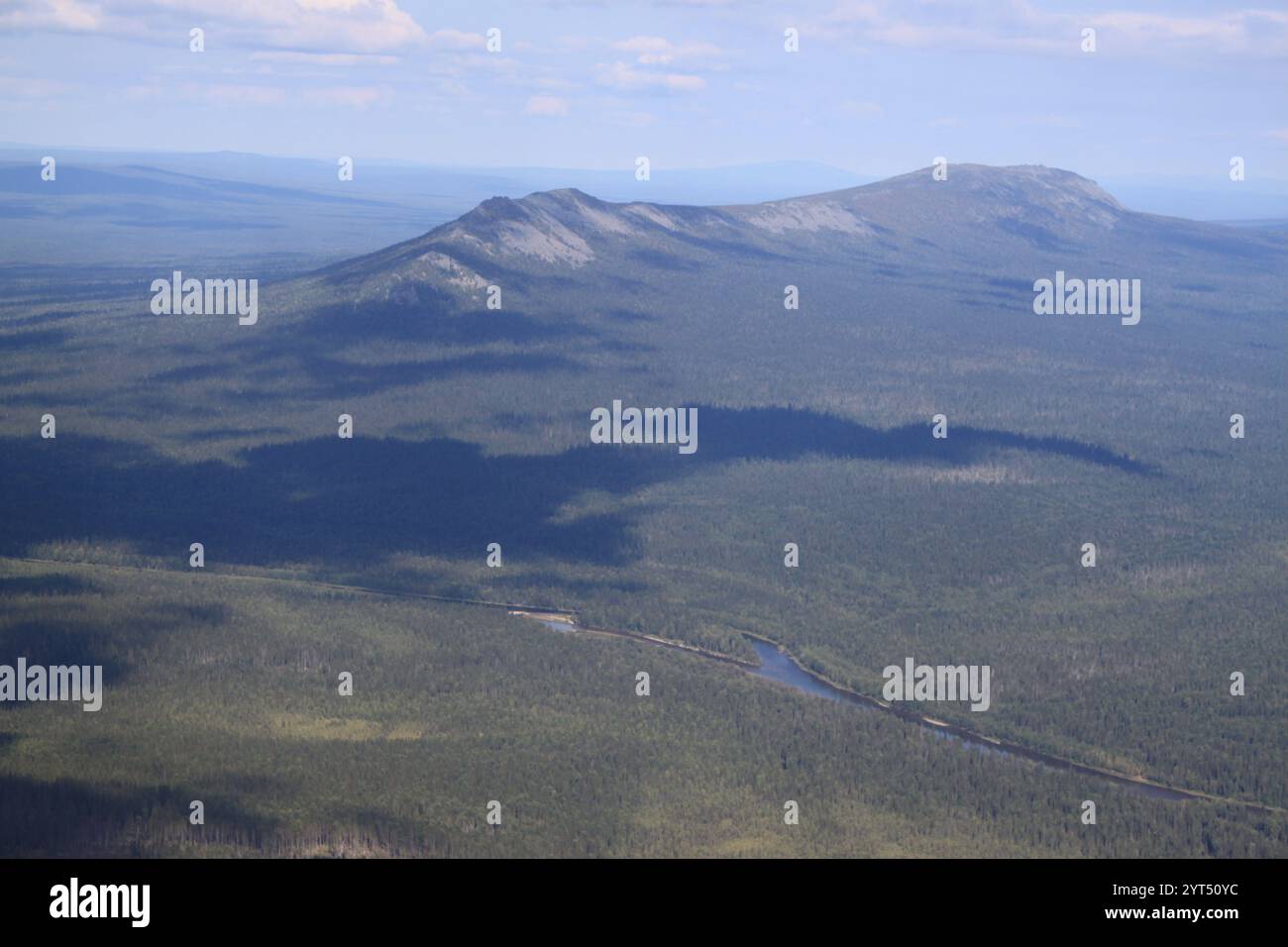 A mountain range is visible in the distance with a blue sky above Stock ...