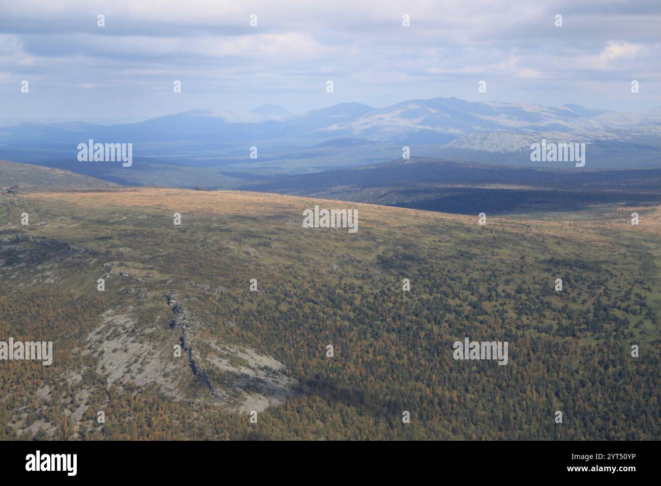 A mountain range is visible in the distance with a blue sky above Stock ...
