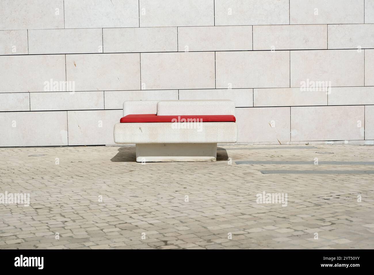 Stone seat with a red cushion Stock Photo - Alamy