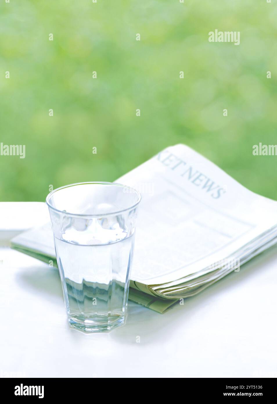 Glass and newspaper Stock Photo - Alamy