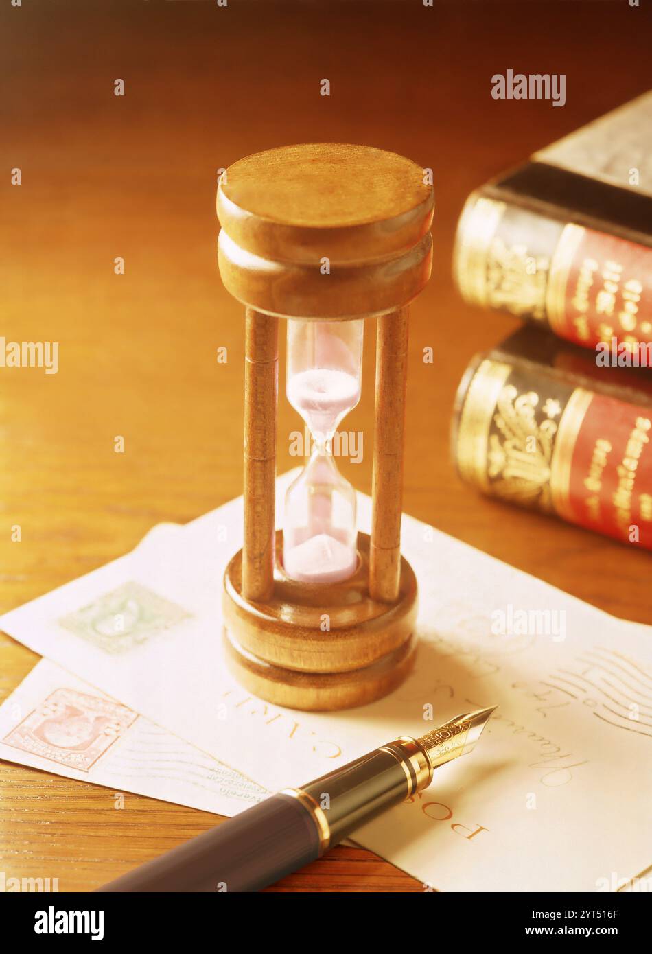 Hourglass, fountain pen and book Stock Photo - Alamy