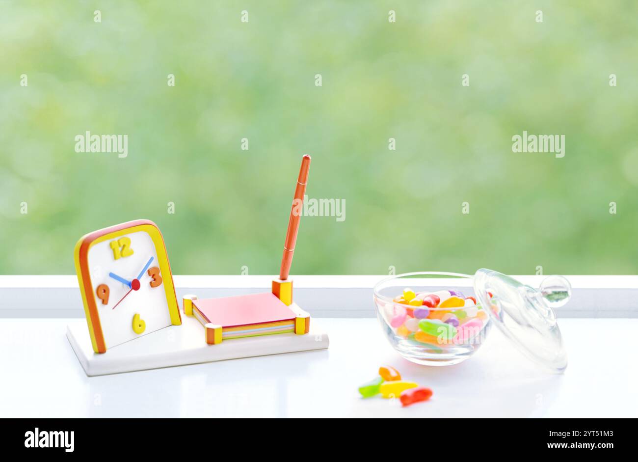 Windowsill clock and sweets Stock Photo - Alamy