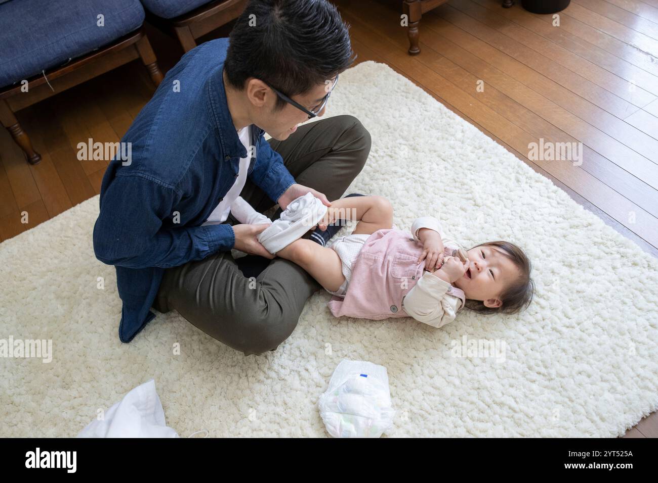 Father changing baby's nappy Stock Photo - Alamy