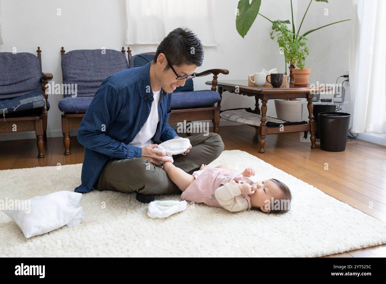 Father changing baby's nappy Stock Photo - Alamy