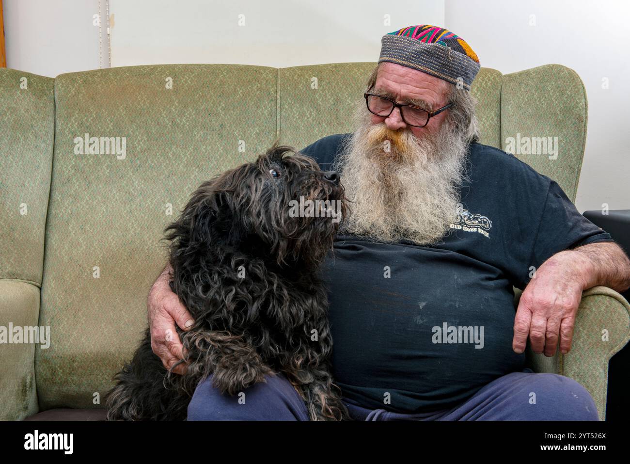 Elderly man living alone with his pet dog Stock Photo - Alamy
