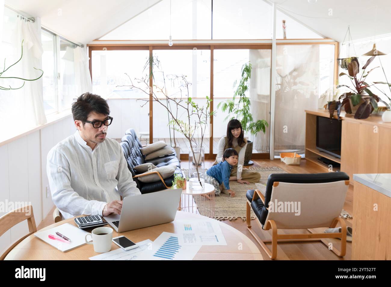 Men working at home and their families Stock Photo - Alamy