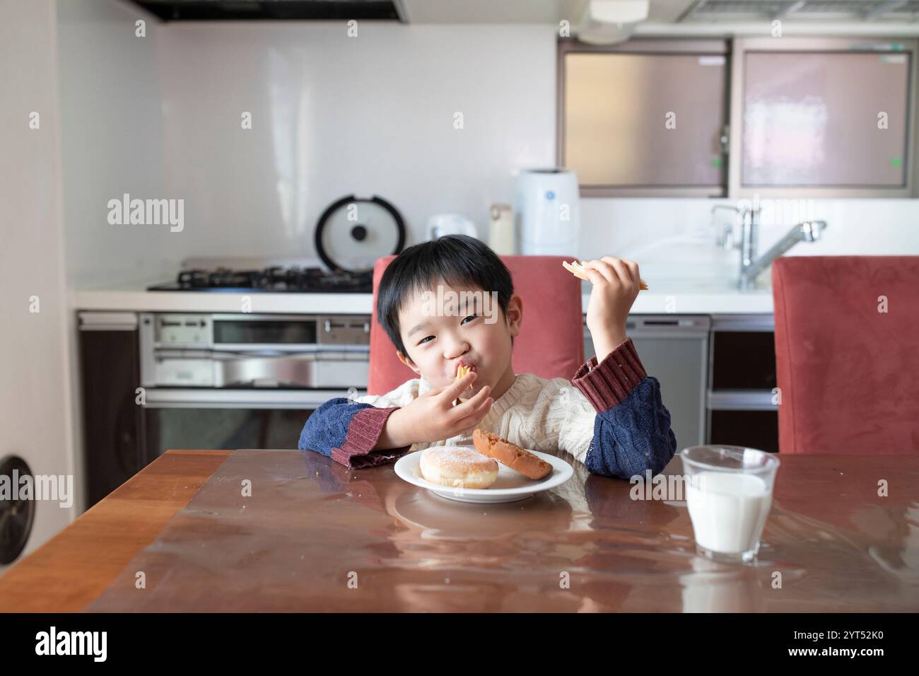 Boy eating snack Stock Photo - Alamy