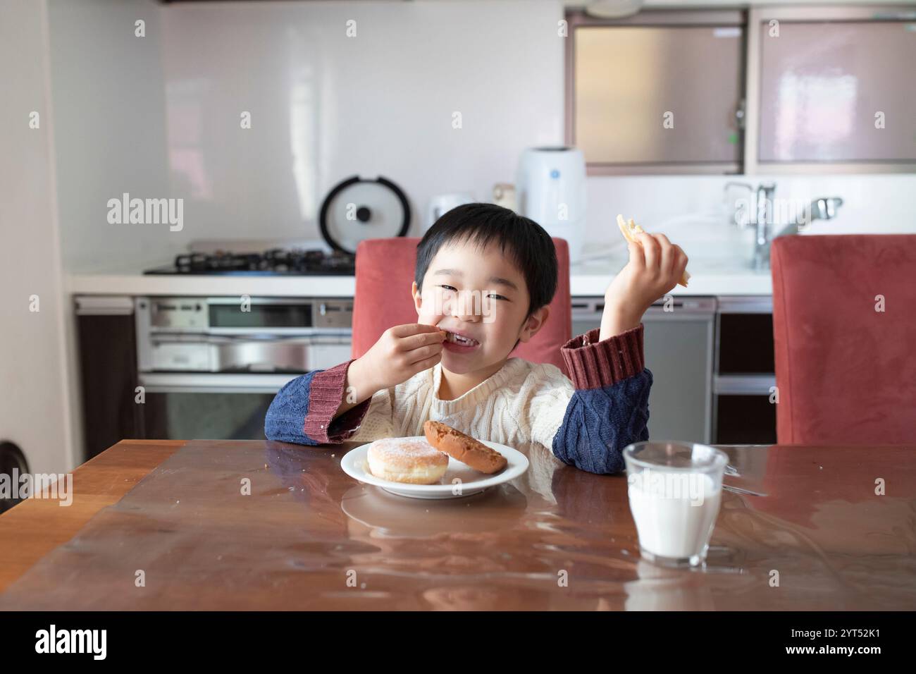 Boy eating snack Stock Photo - Alamy