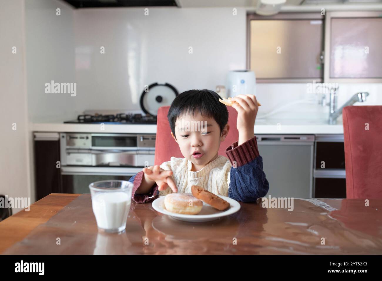 Boy eating snack Stock Photo - Alamy
