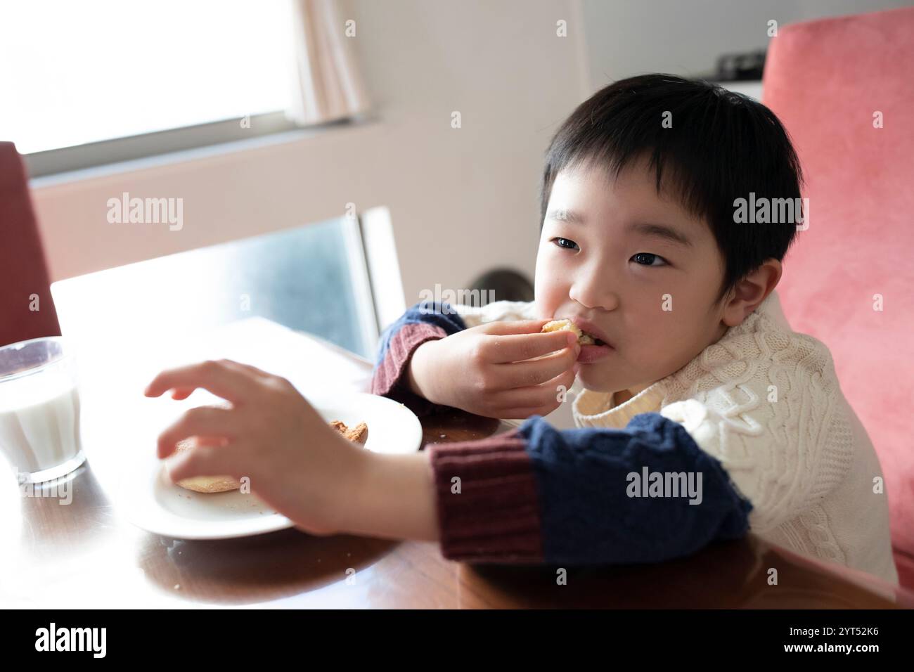 Boy eating snack Stock Photo - Alamy
