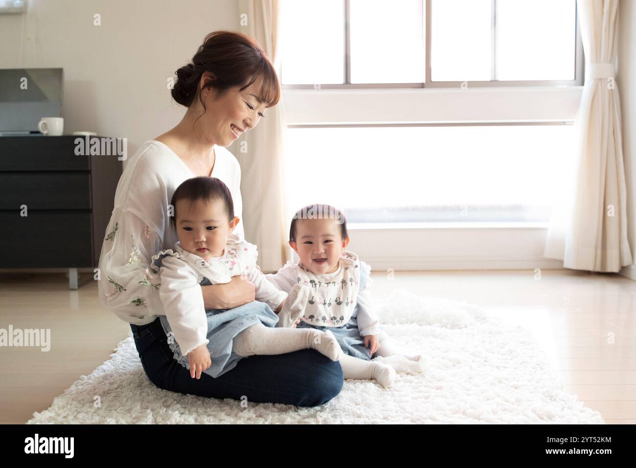 The cradle and child sitting on the floor hi-res stock photography and ...