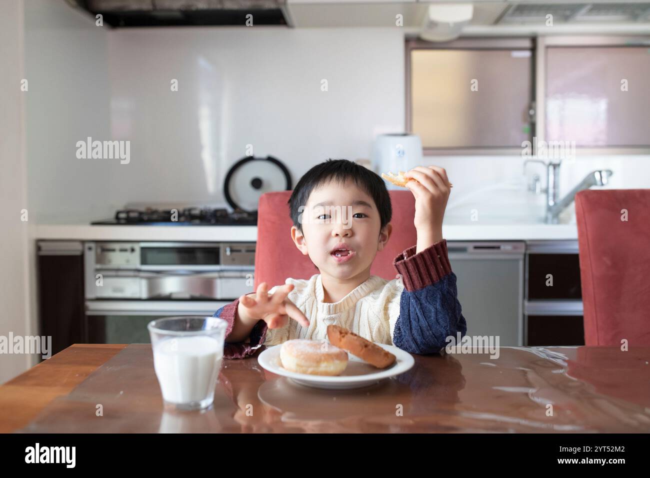 Boy eating snack Stock Photo - Alamy
