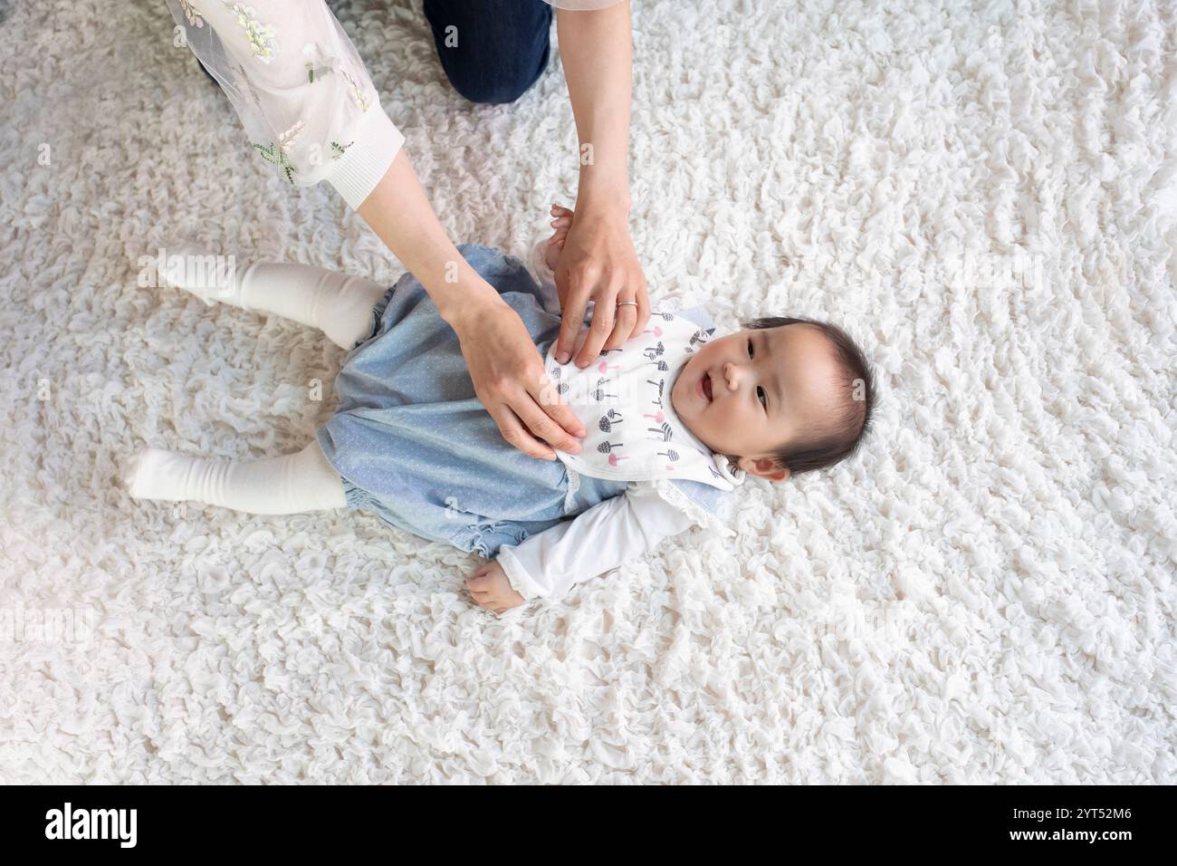 Baby on back and mother's hand Stock Photo - Alamy