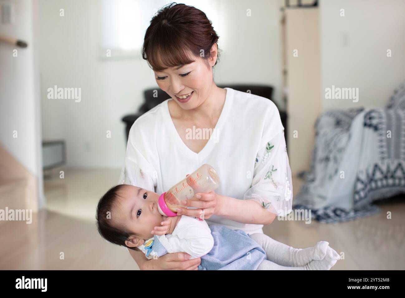 Mother giving milk to baby Stock Photo - Alamy