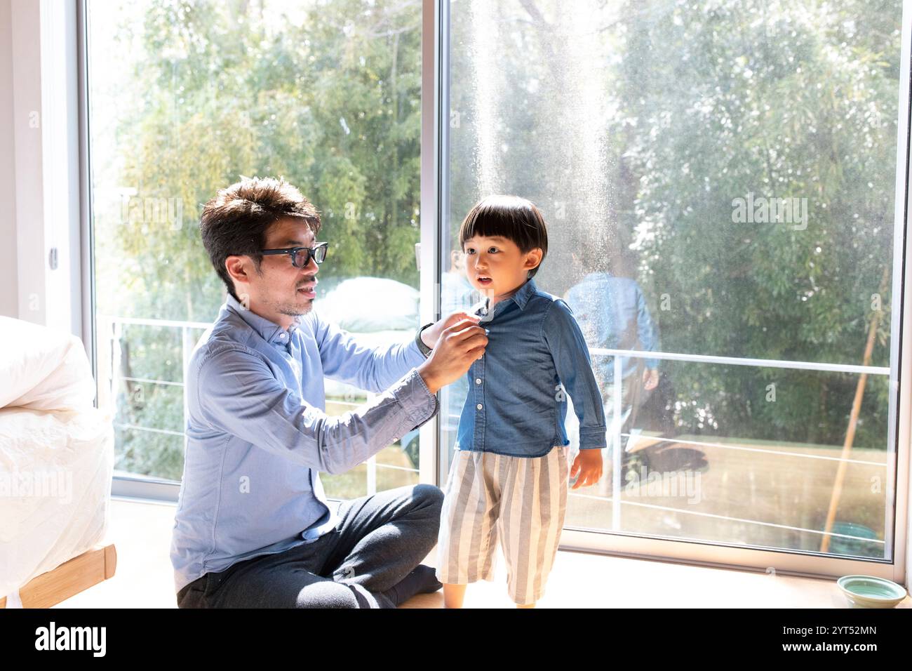 Father changing child's clothes Stock Photo - Alamy