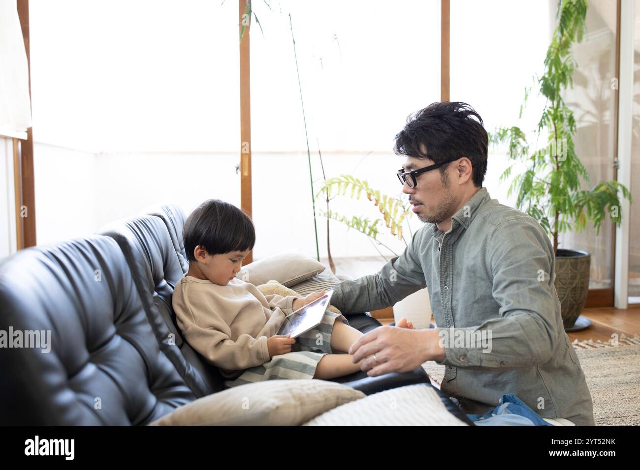 Father looking after his child Stock Photo - Alamy
