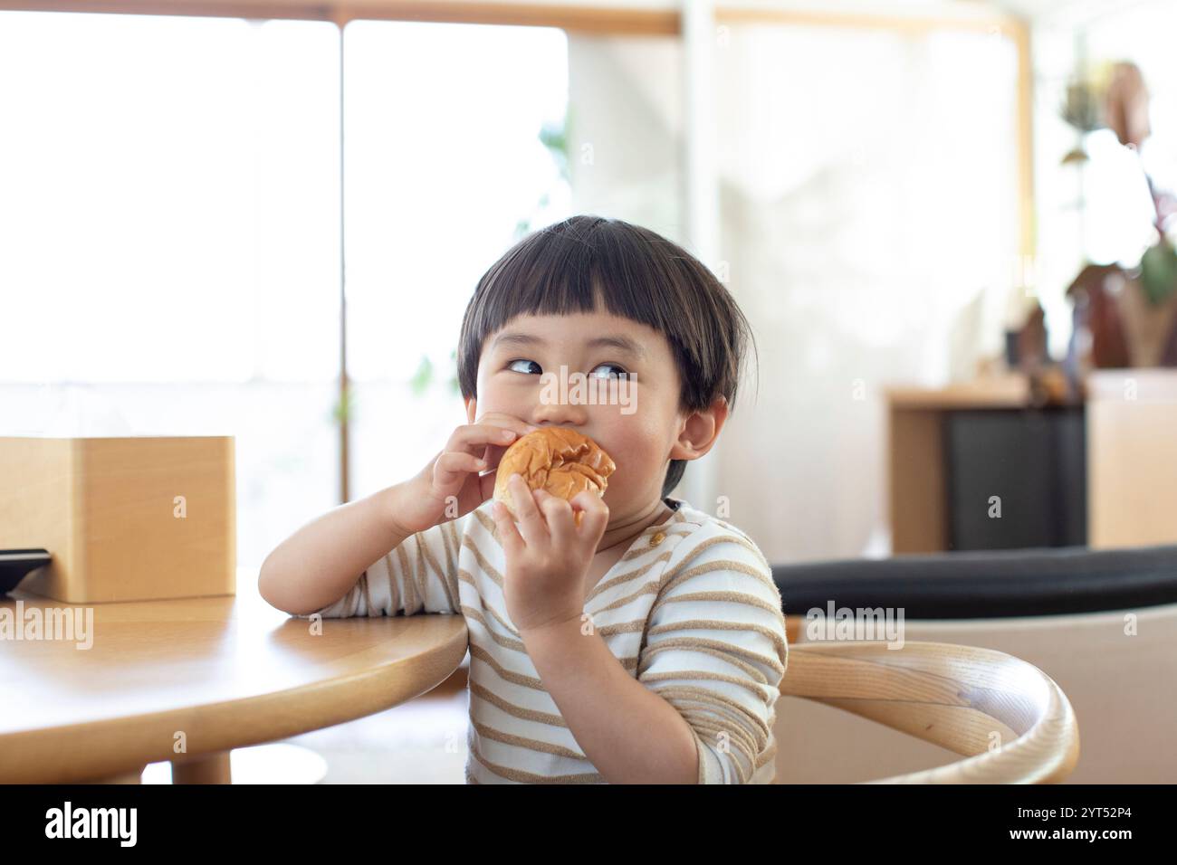 Boy eating bread Stock Photo - Alamy