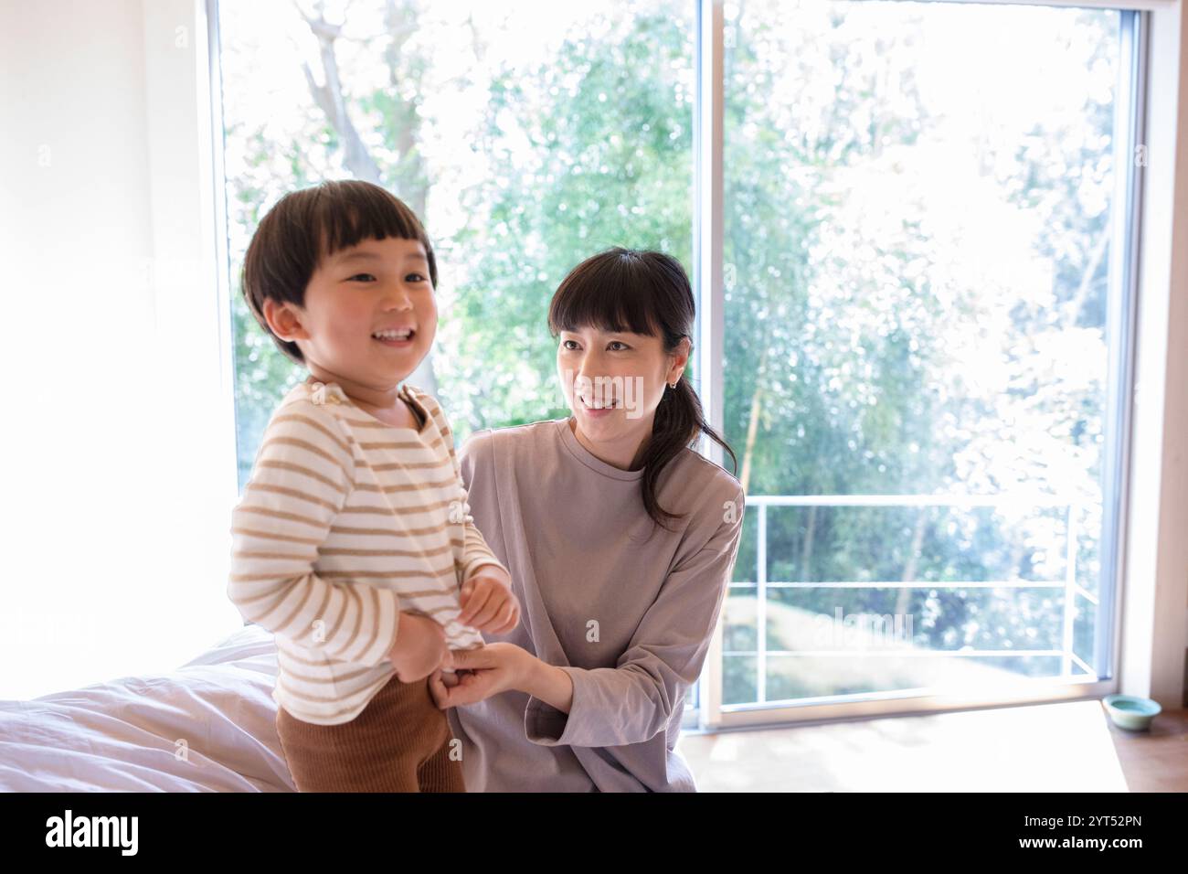 Mother caring for her child Stock Photo - Alamy