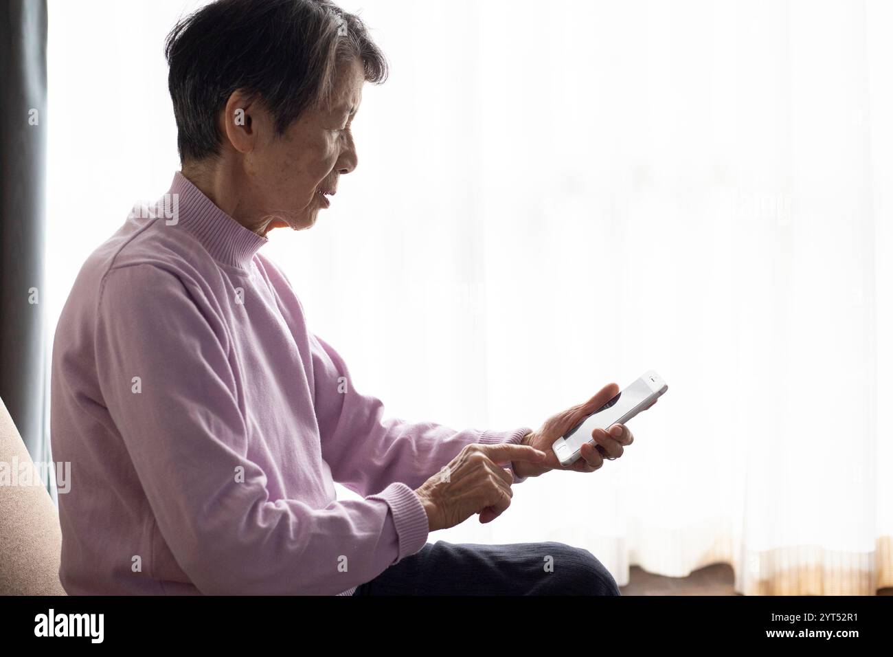 Senior woman operating a smartphone Stock Photo - Alamy