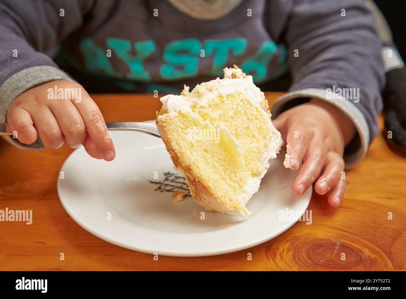 Boy eating cake in hand Stock Photo - Alamy