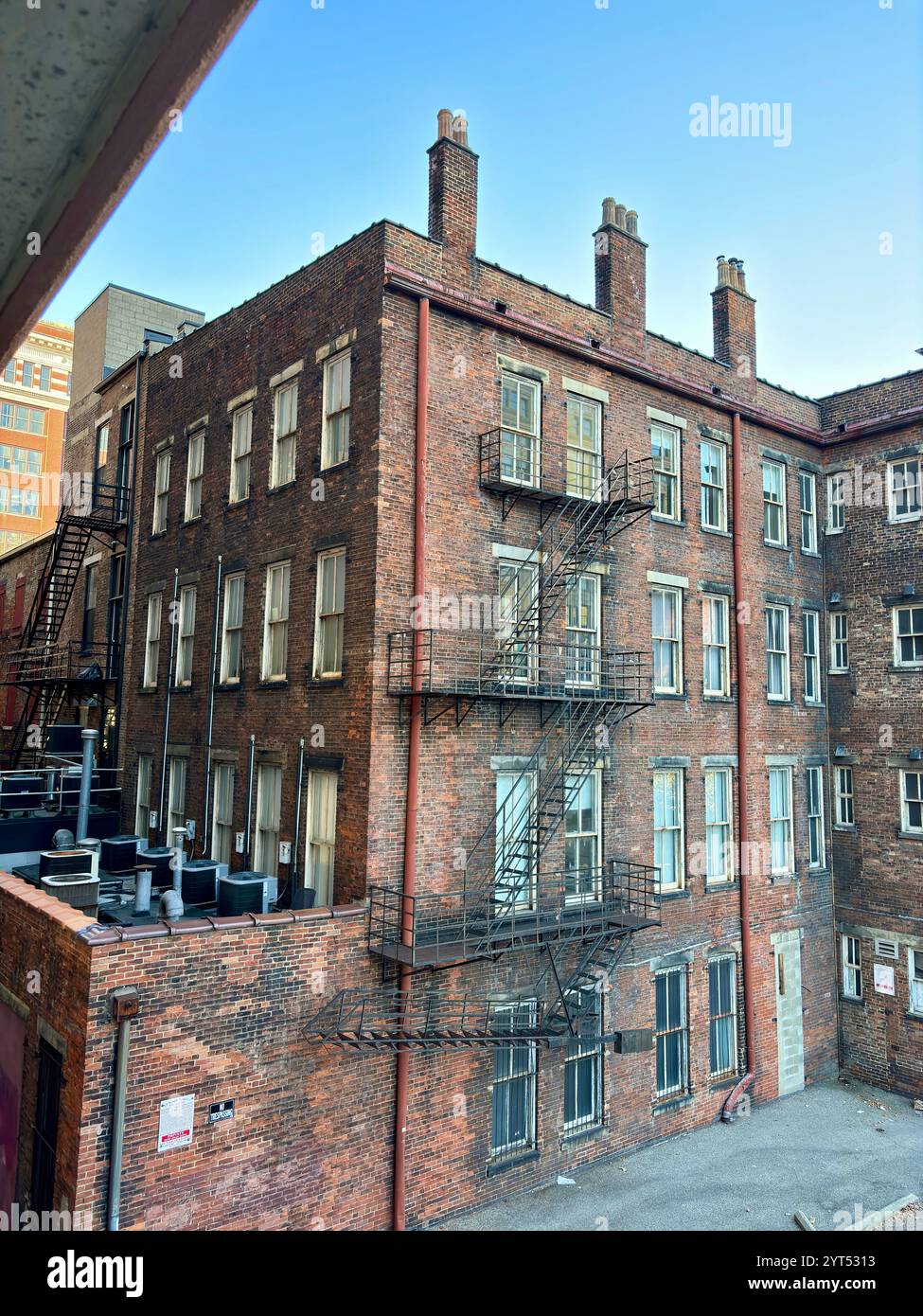 Classic brick building with fire escapes & rooftop view Stock Photo - Alamy